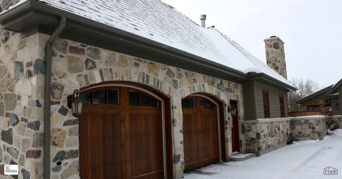 Double car garage with stone siding with Stone Siding by Masonal Stone Inc