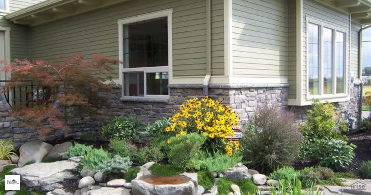 Exterior Landscaping with Stone Siding by Winsome Construction