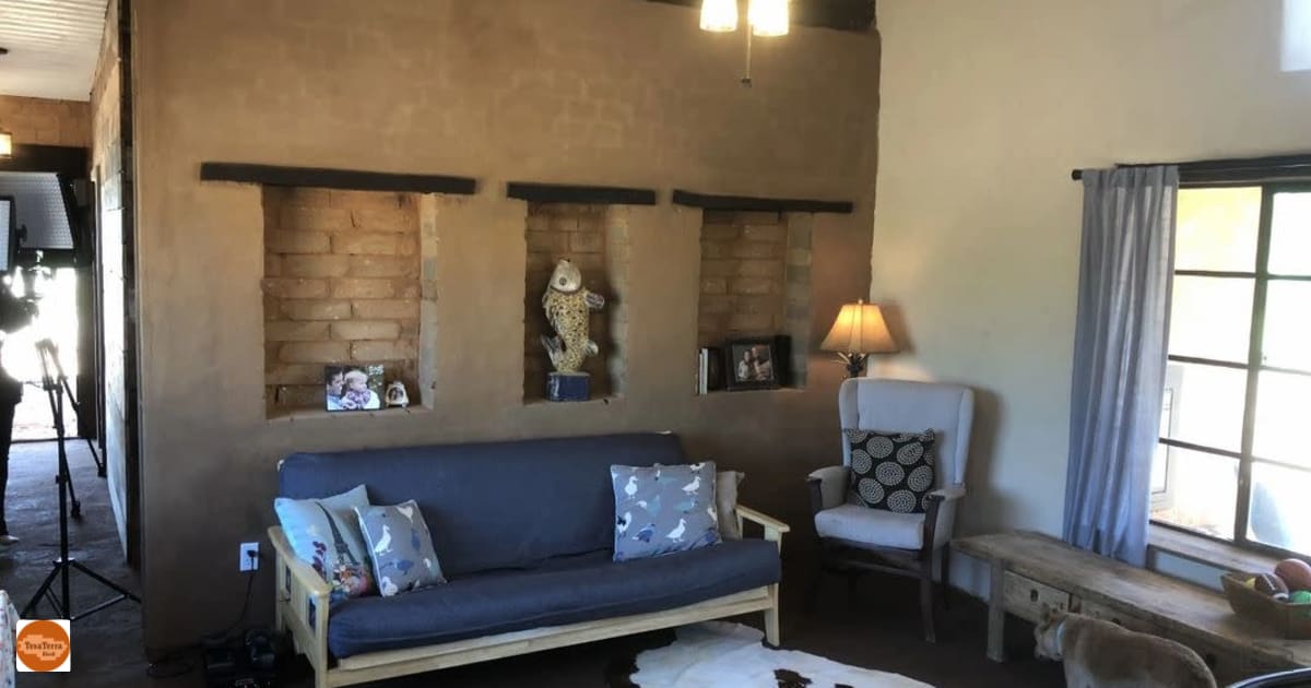 Compressed earth block home living room with Electrical Outlet by ...