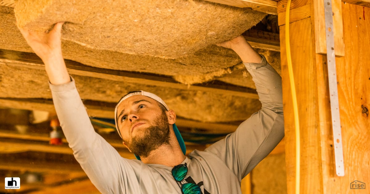 Pressing HempWool Into Place with Hemp Batt Insulation by Hempitecture