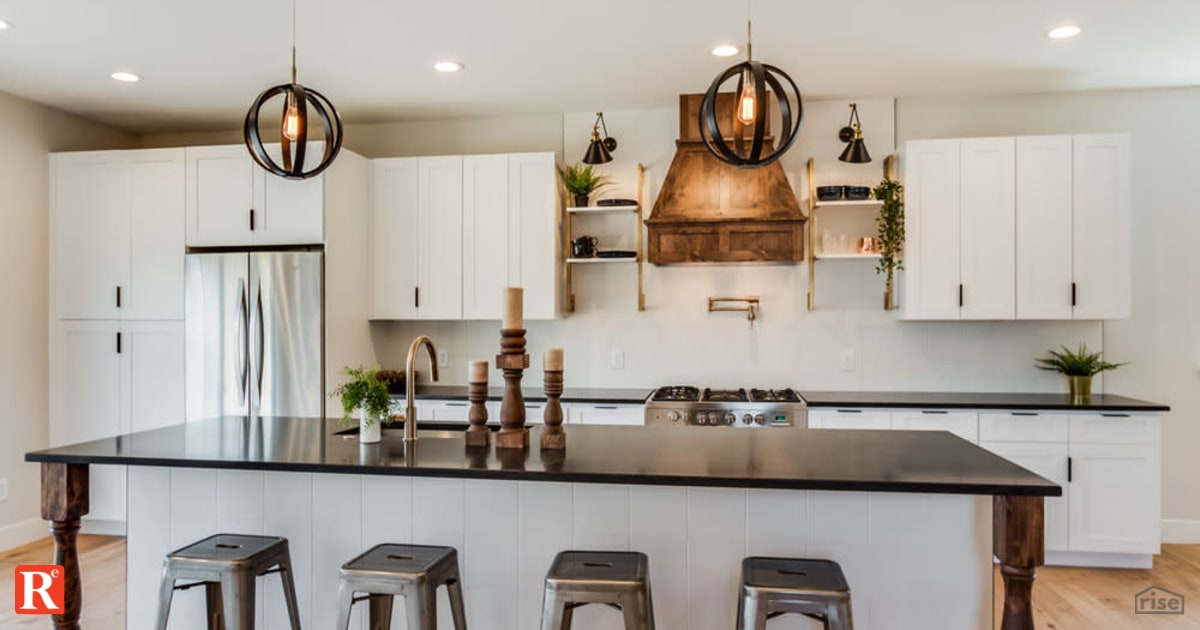 Bright white open concept kitchen with Gas Range by Revolve Design Build