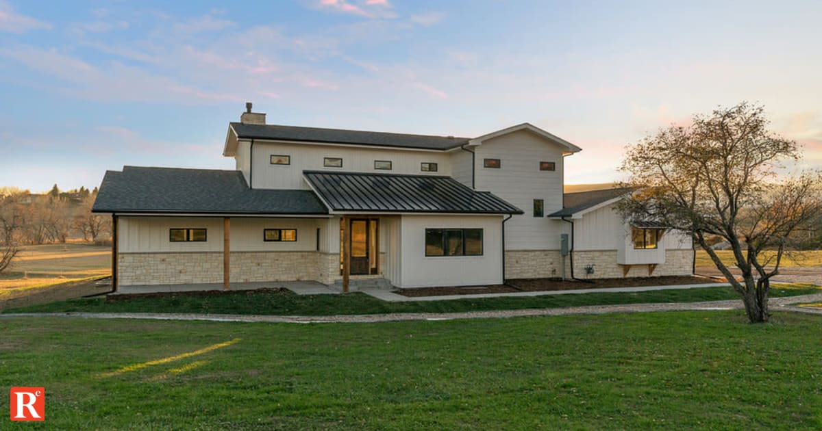 Modern farmhouse exterior with Stone Siding by Revolve Design Build