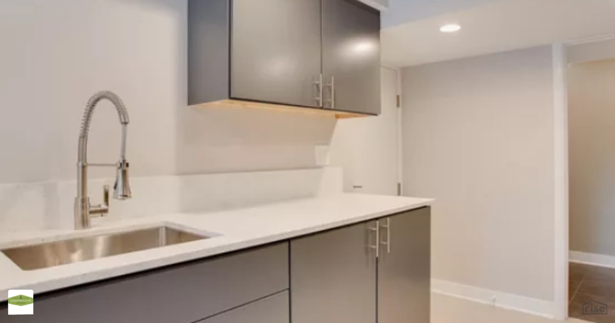 Kitchen with Low-Flow Kitchen Faucet by Constructive Builders