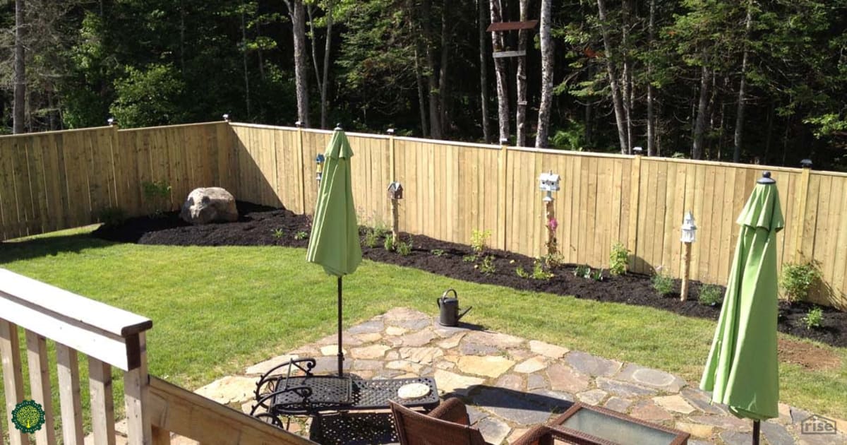 Backyard Patio with Wood Mulch by Earthworks Landscape & Design