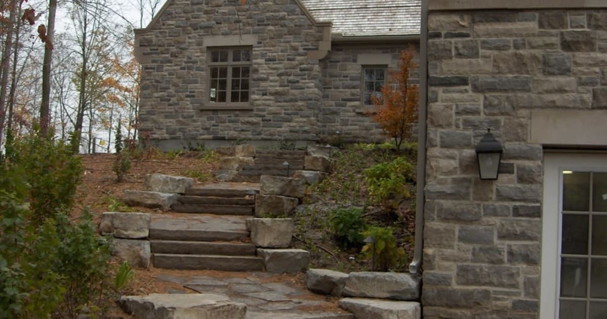 Stone home with custom stone walkway with Stone Siding by Masonal Stone Inc