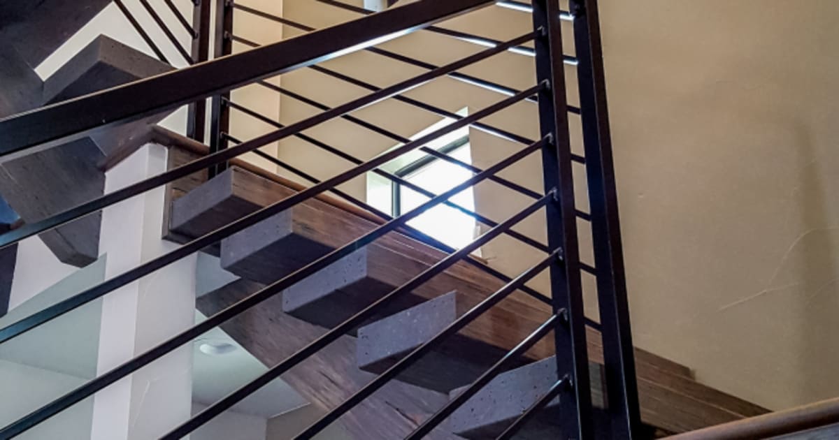 Rise | Main floor staircase and stairwell, featuring industrial metal ...