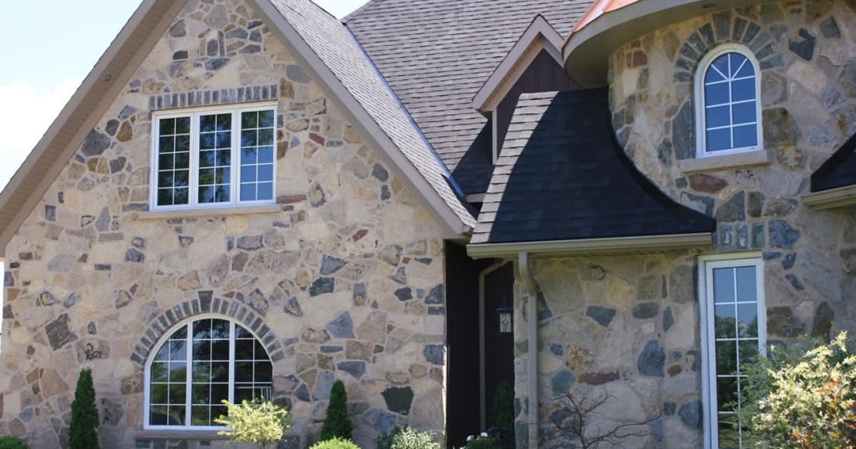 Rise | Stone house with feature metal roof with Standing Seam Metal ...