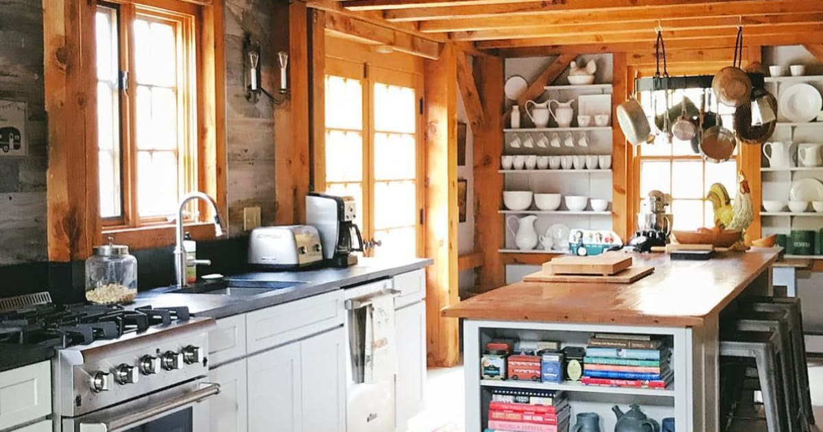 Rise | Rustic kitchen with finished countertop, windows and rafters ...