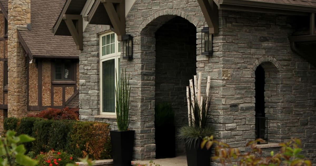 Stone arch entryway with Stone Siding by Masonal Stone Inc