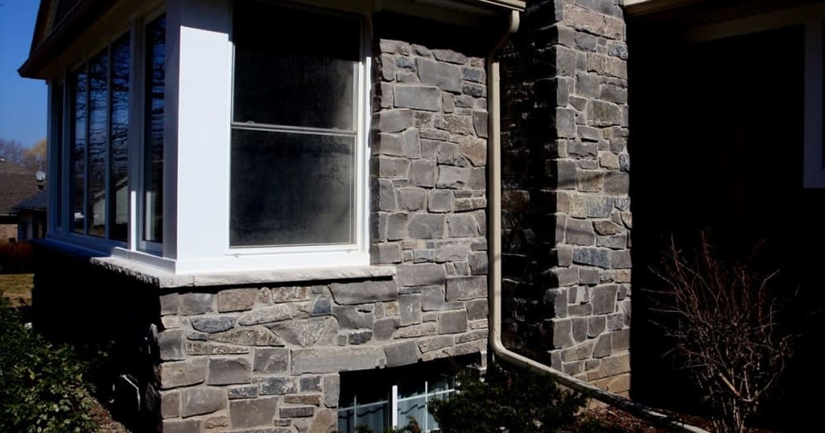 Rise | Stone sided single level home with Stone Siding by Masonal Stone Inc