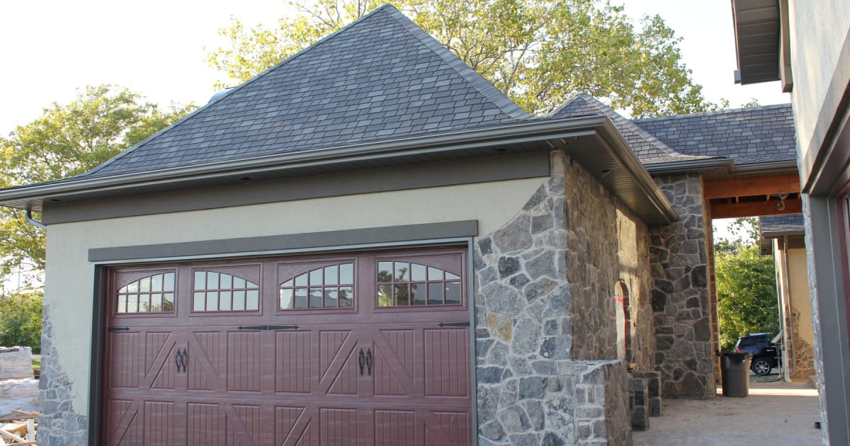 Rise | Garage with stone siding with Stone Siding by Masonal Stone Inc