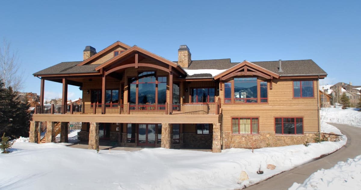 Rise | Home exterior with large windows with Stone Siding by Alpen High ...