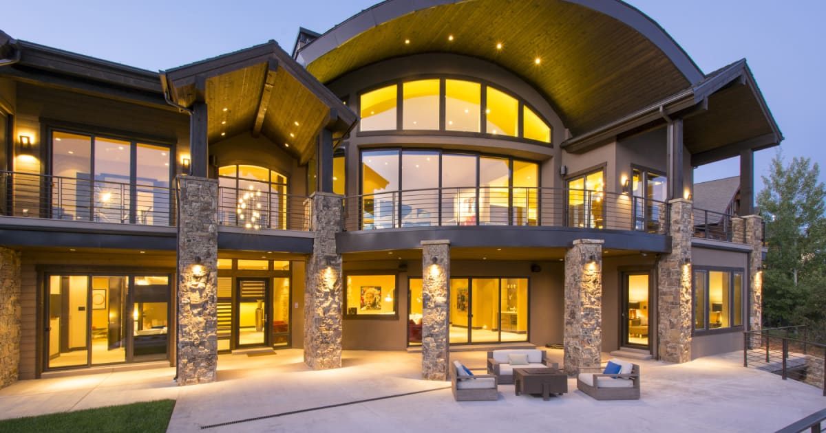 Rise | Window-lined exterior view from back patio with Stone Siding by ...